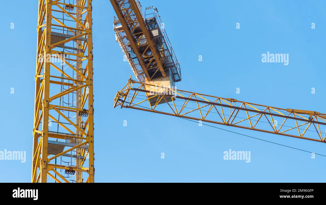 Construction crane at work on a busy building site Stock Photo - Alamy