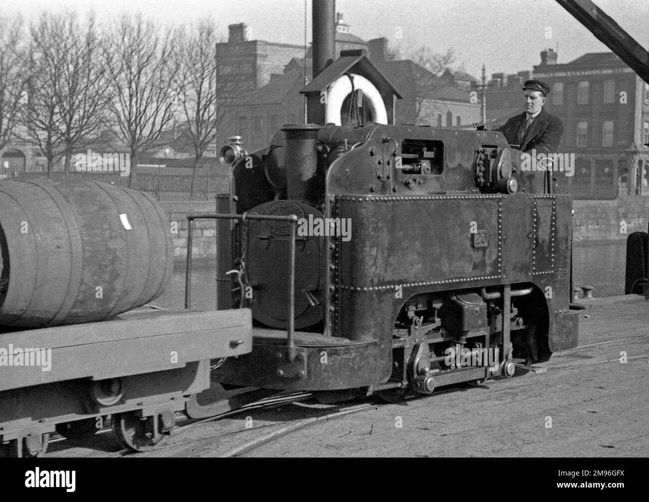 A man driving a tram engine to transport barrels Stock Photo - Alamy