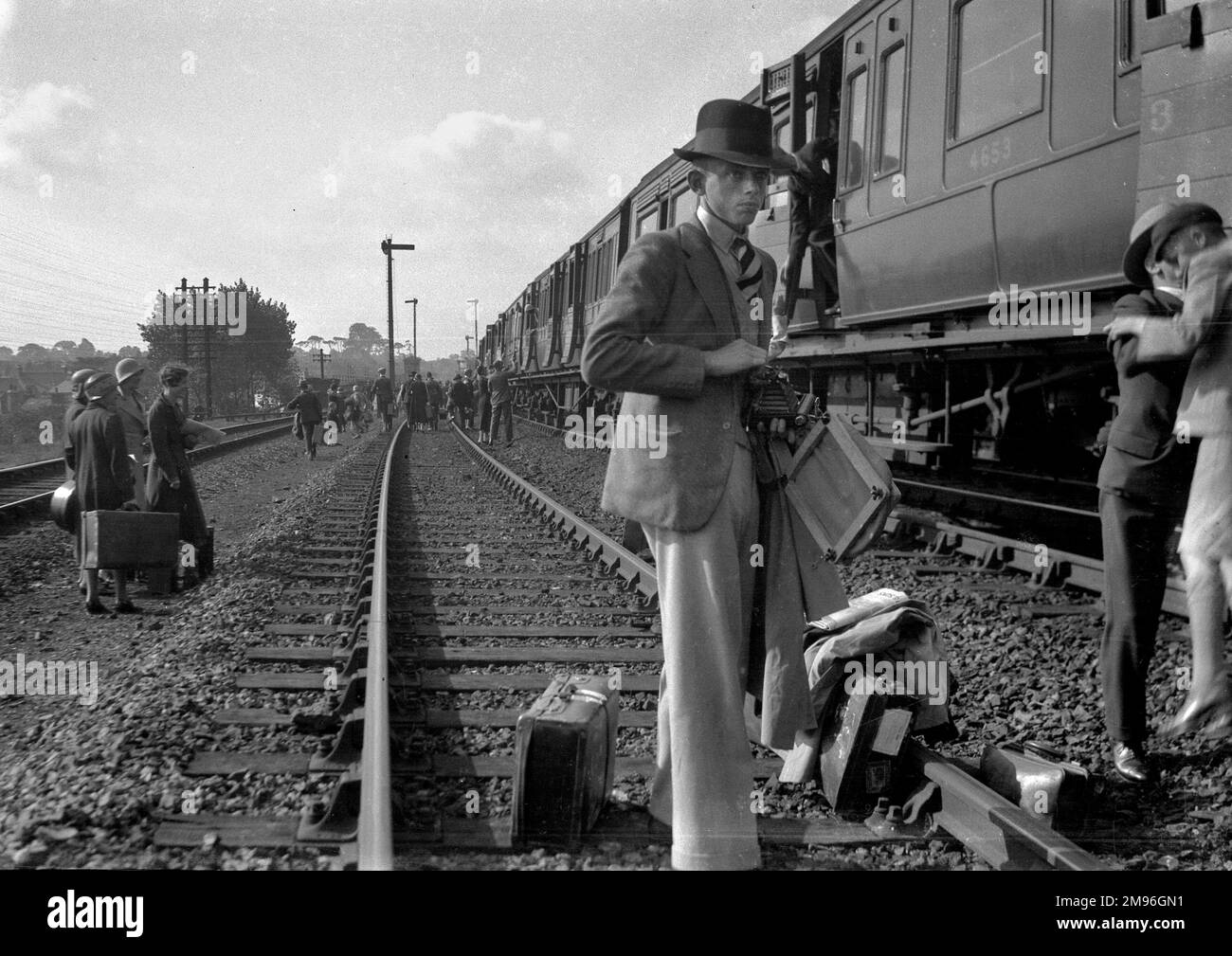 People on a railway track alongside a halted train Stock Photo - Alamy