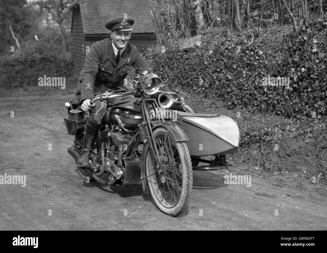A man in RAF uniform riding a motorbike with a sidecar attached Stock ...