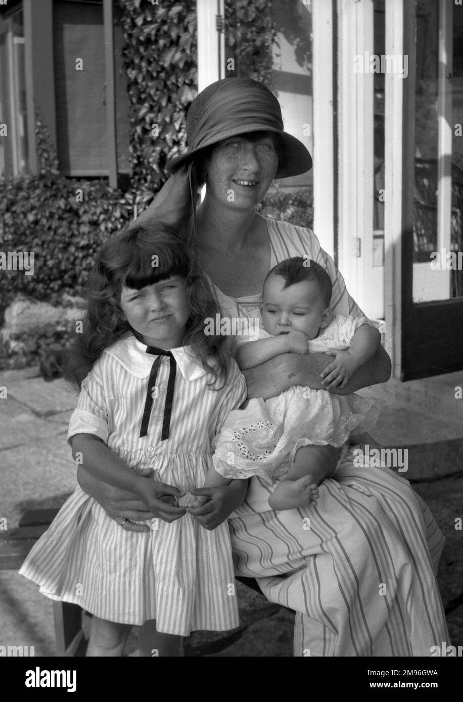 A woman with two children, a little girl and a baby Stock Photo - Alamy