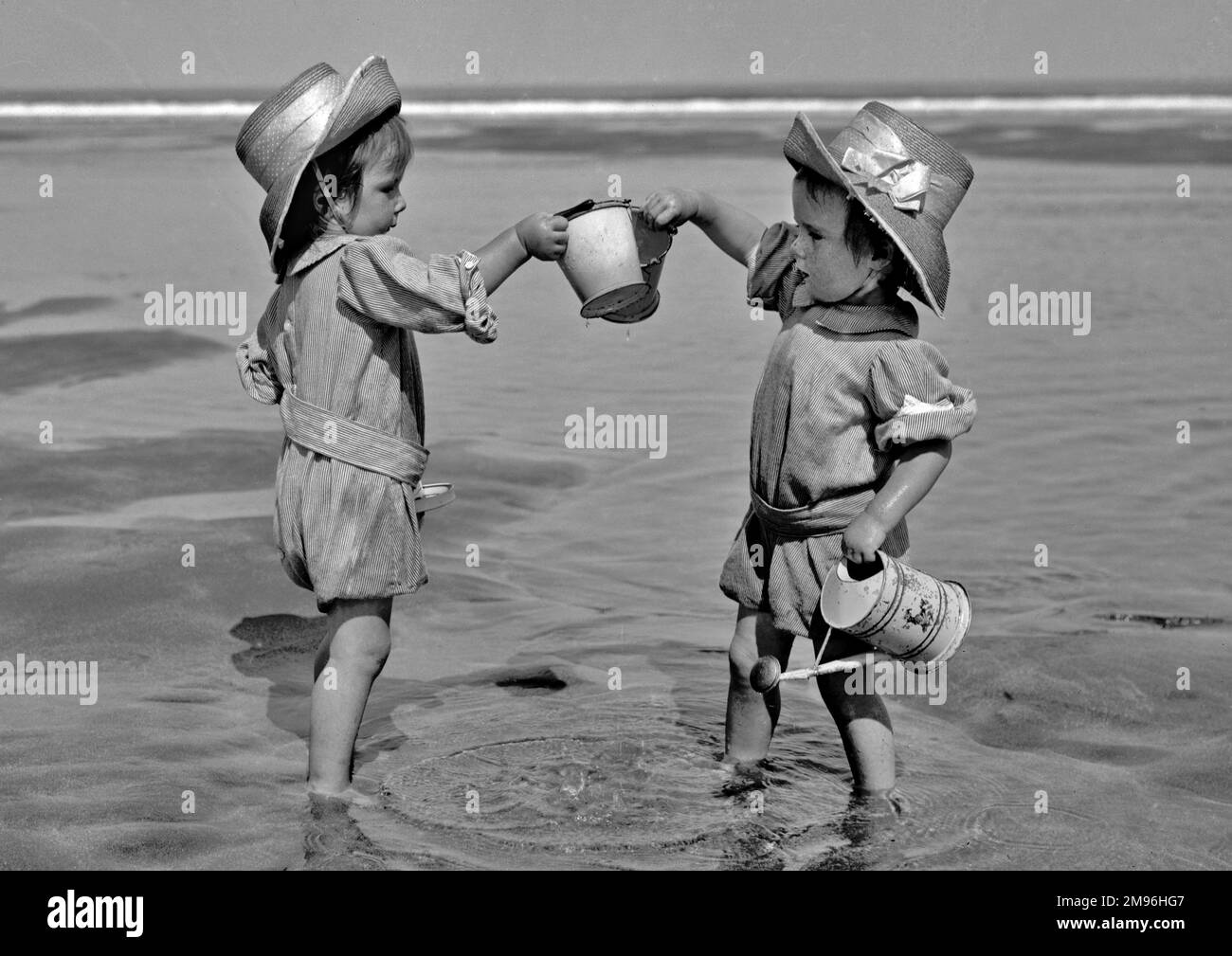 Child paddling in sea bucket hi-res stock photography and images - Alamy