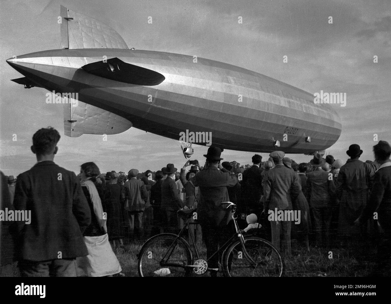 The German Graf Zeppelin airship hovering above the ground, with a ...