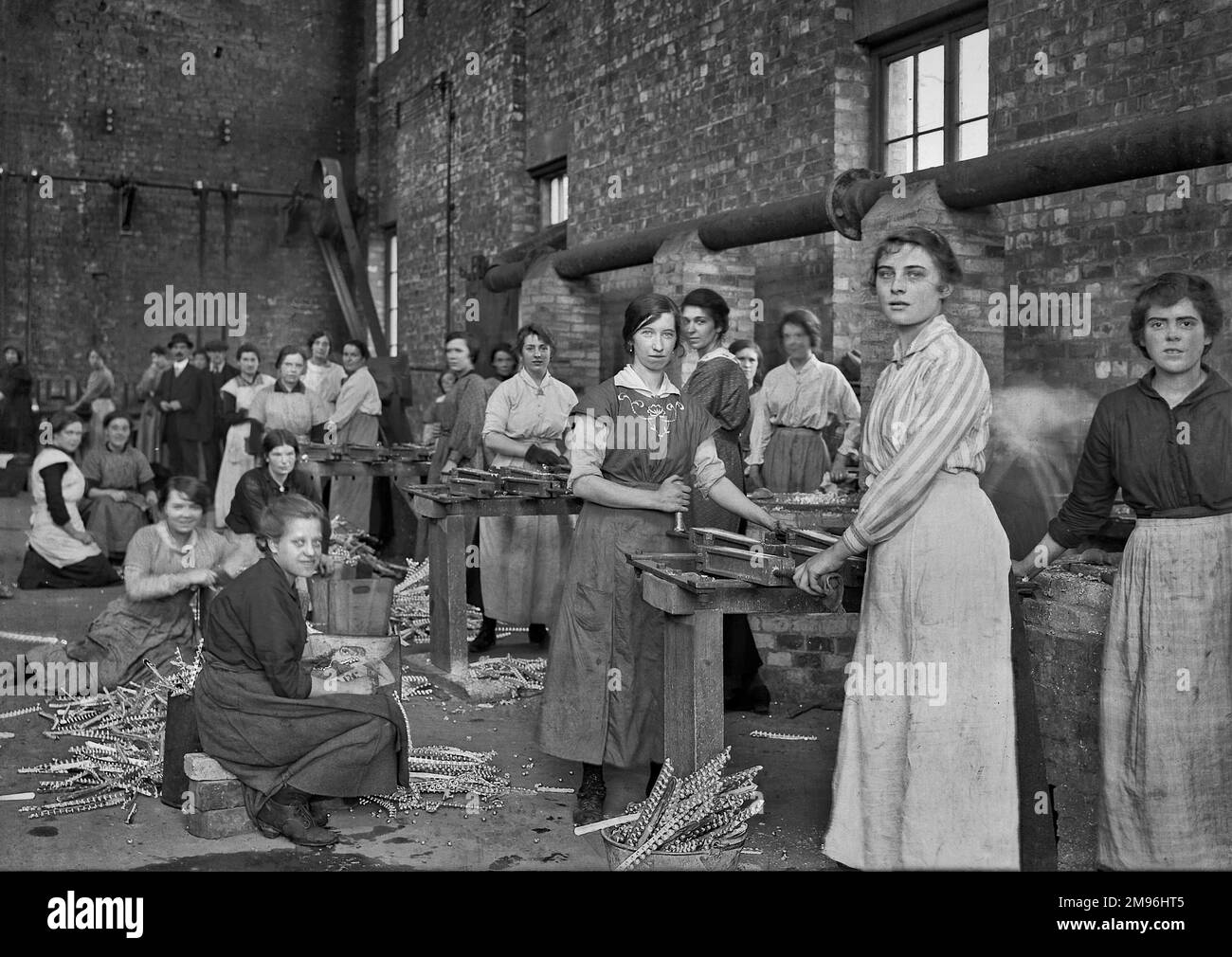 A group of manual workers, mostly women, inside a factory - WW1 era ...