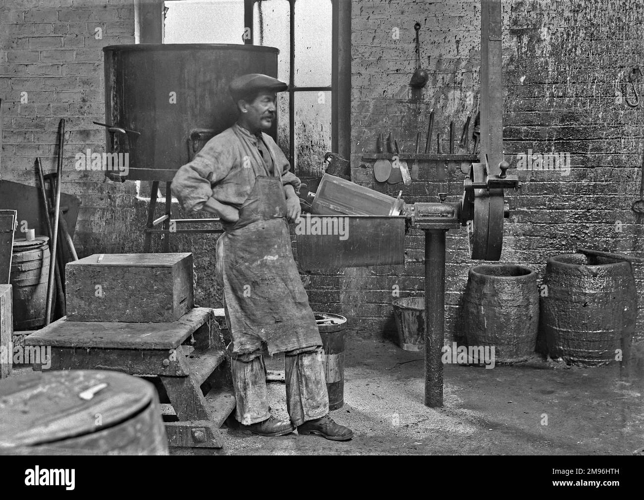 A workman in a factory, having a break from his work. The factory ...