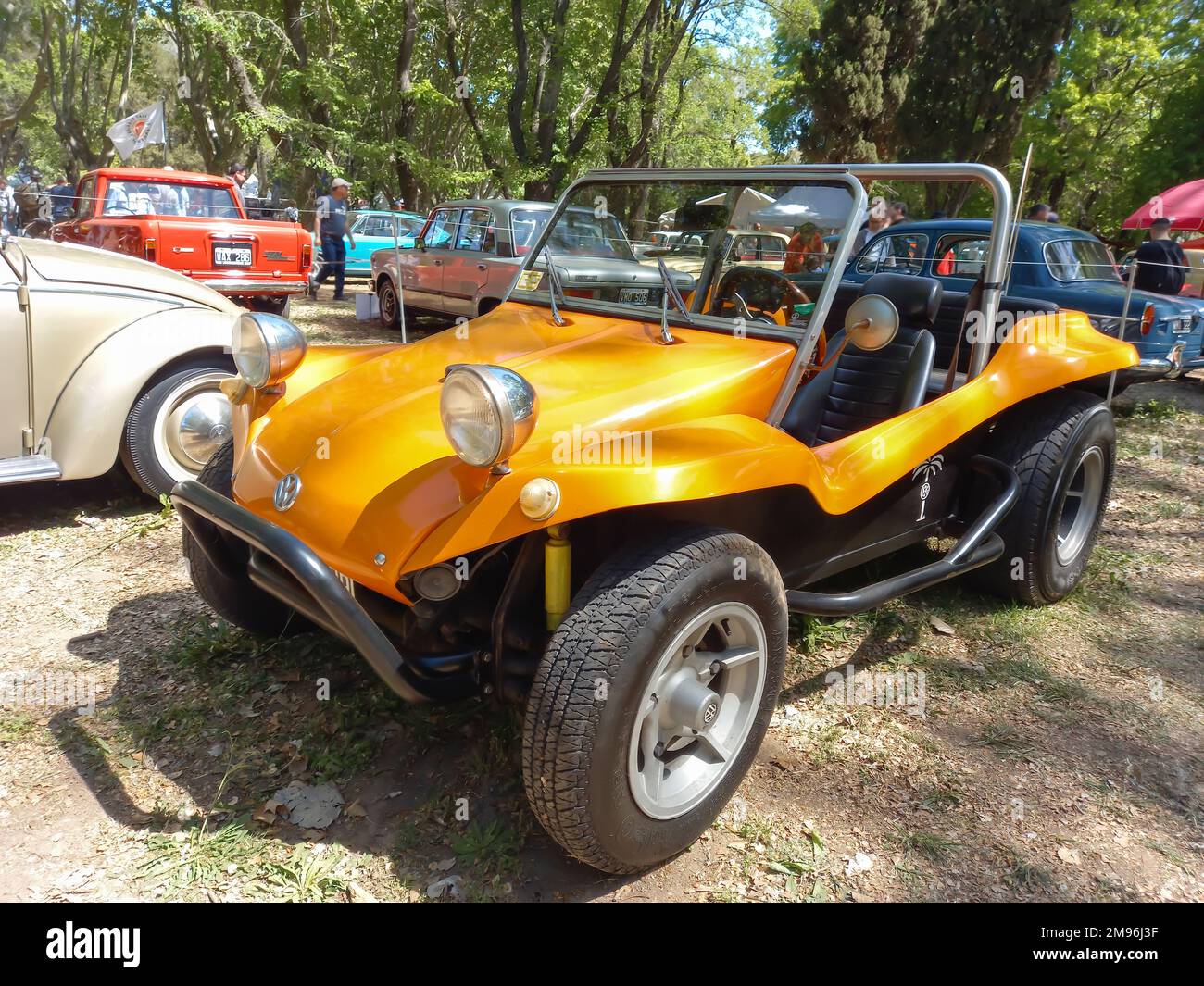 Old yellow Volkswagen beach dune buggy in a park. Nature, trees ...