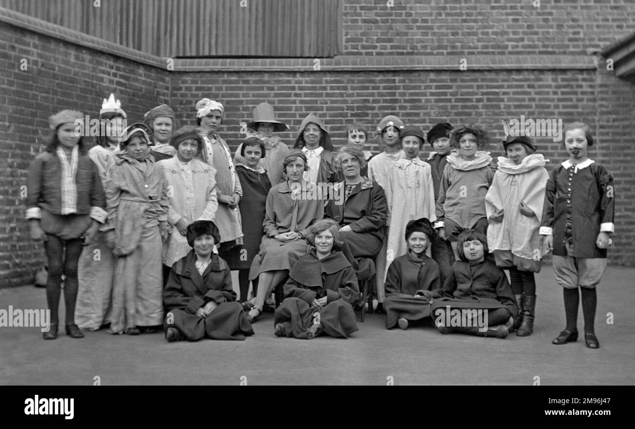 A class of children and two teachers. The children are in costume for a ...