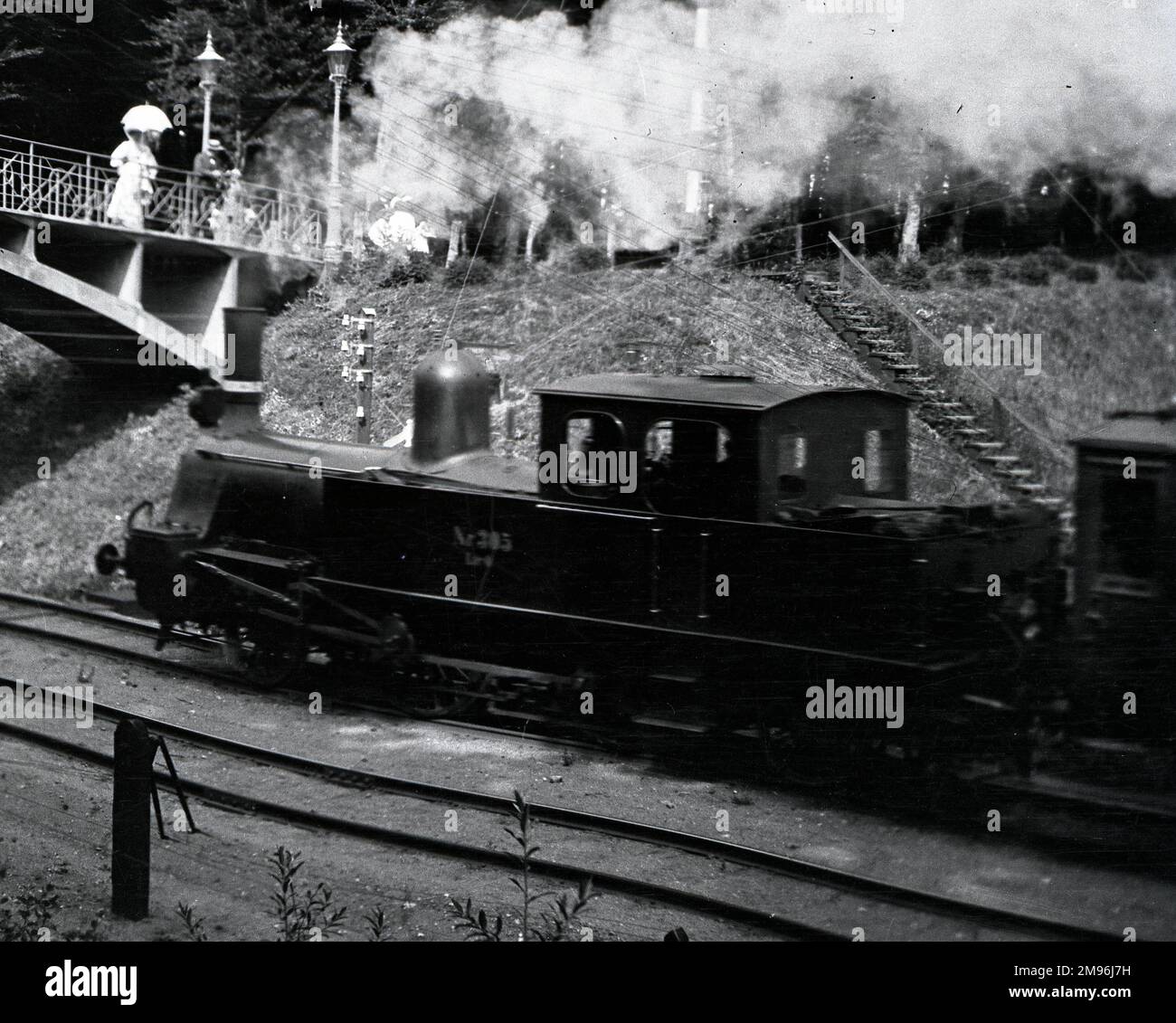 A steam train approaching a bridge Stock Photo - Alamy