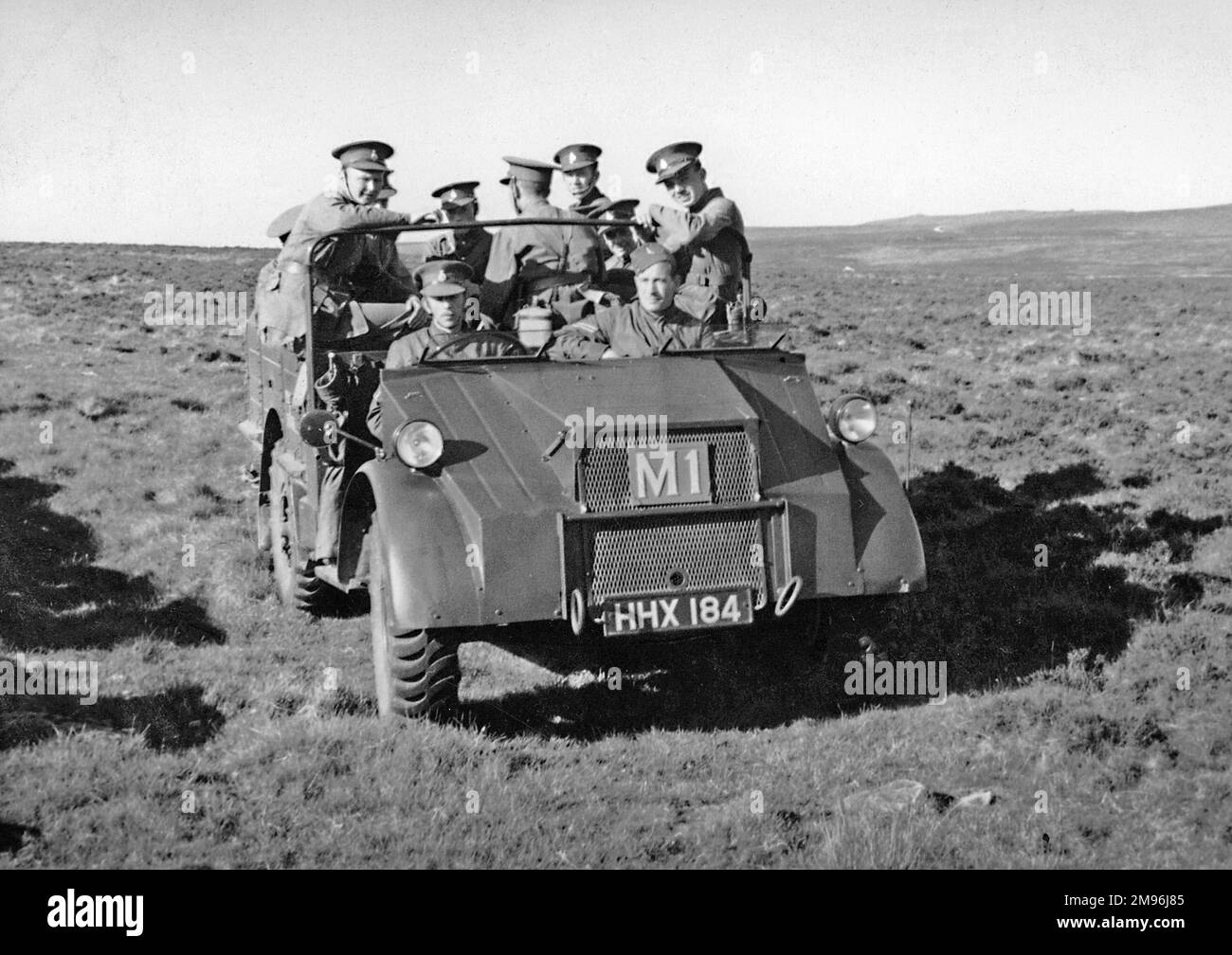 A group of soldiers in a jeep, driving across a field near Okehampton ...