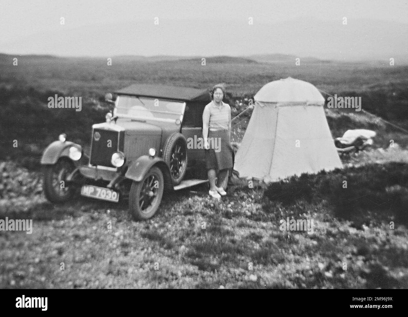 A Woman Standing Between A Parked Car And A Circular Tent On The Isle Of Skye Scotland Stock