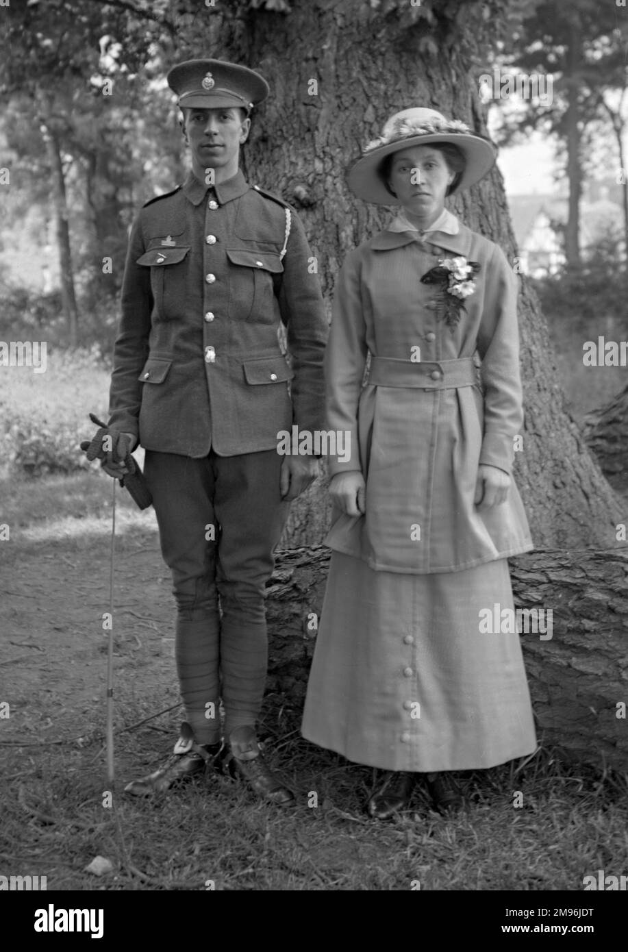 A soldier and his girlfriend posing for their photo in front of a tree ...