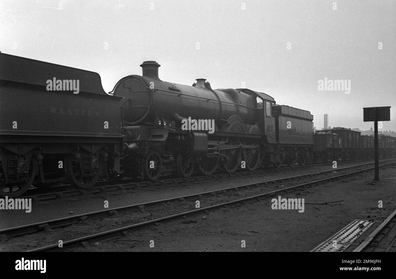 A Great Western steam engine on a railway track, with tender and trucks ...