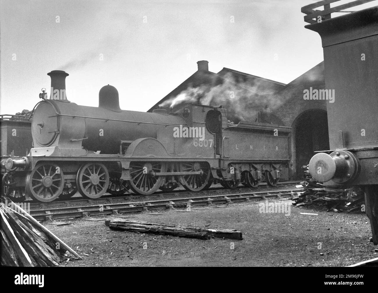 An LNER (London & North Eastern) steam engine and tender on a railway ...