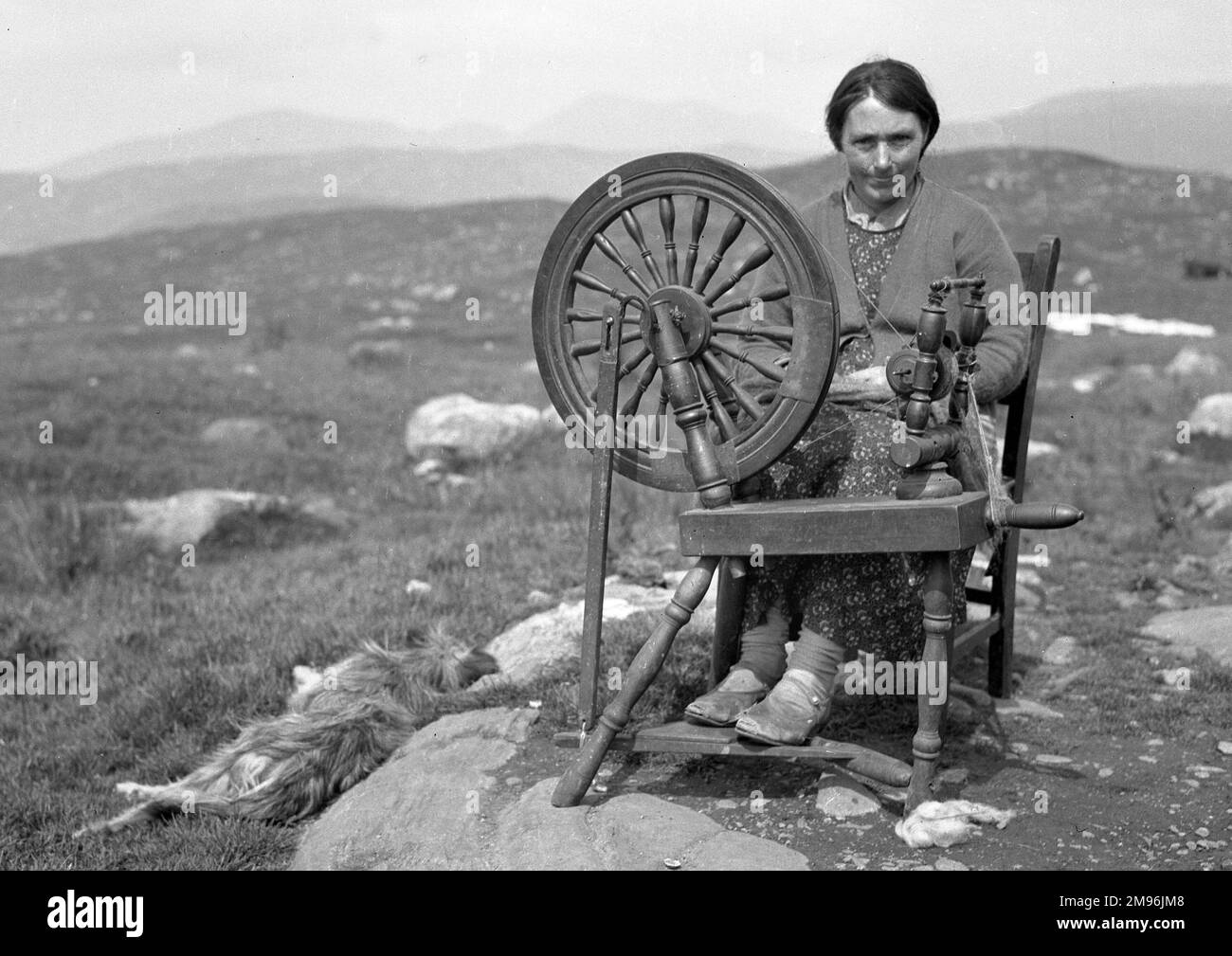 On the Isle of Harris, Scotland, a woman uses an elegant old spinning ...