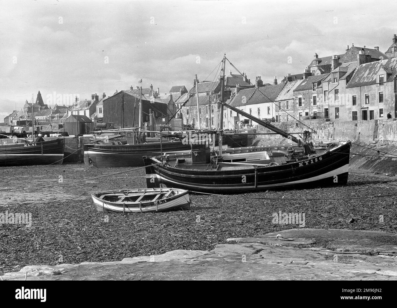 Harbour scene in Scotland with fishing boats and houses Stock Photo - Alamy