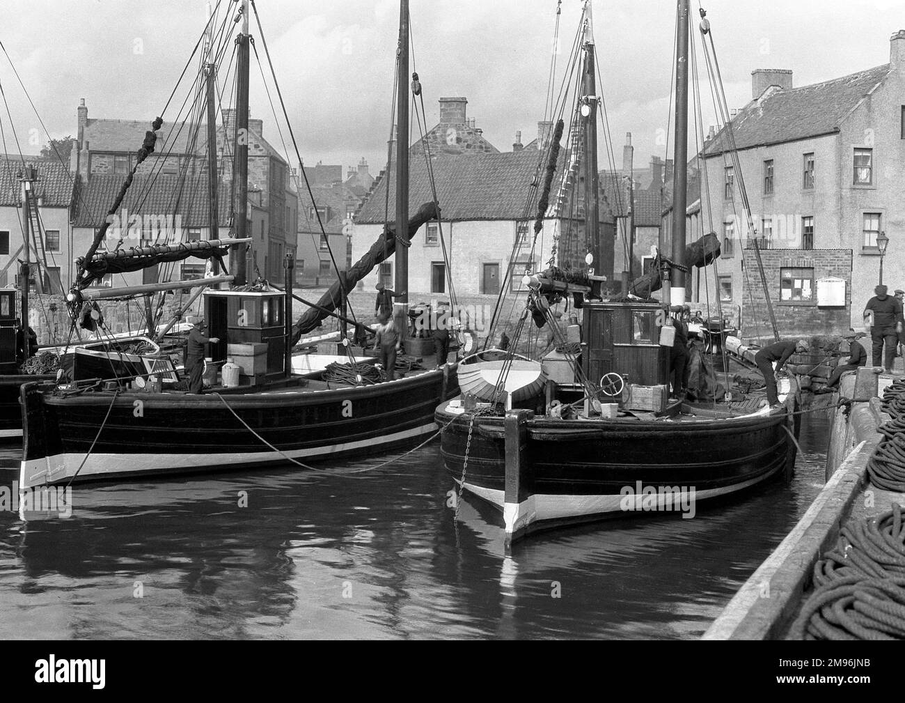 Harbour scene in Scotland with fishing boats and houses Stock Photo - Alamy