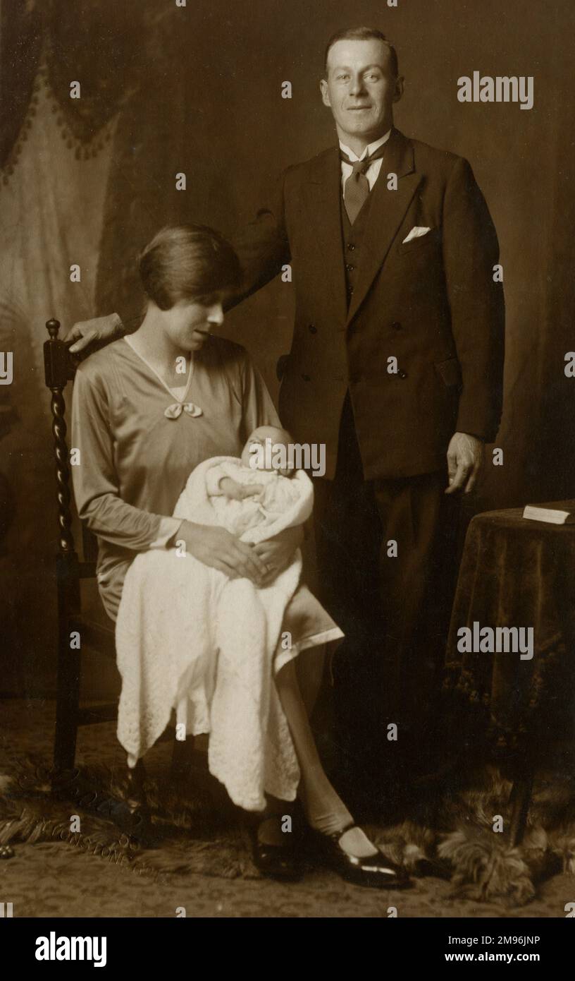 New parents proudly show off their baby in this family portrait Stock ...