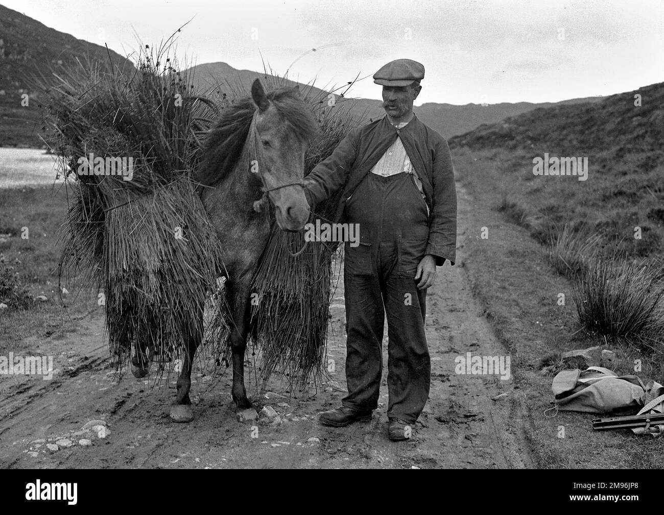 Man carrying hay Black and White Stock Photos & Images - Alamy