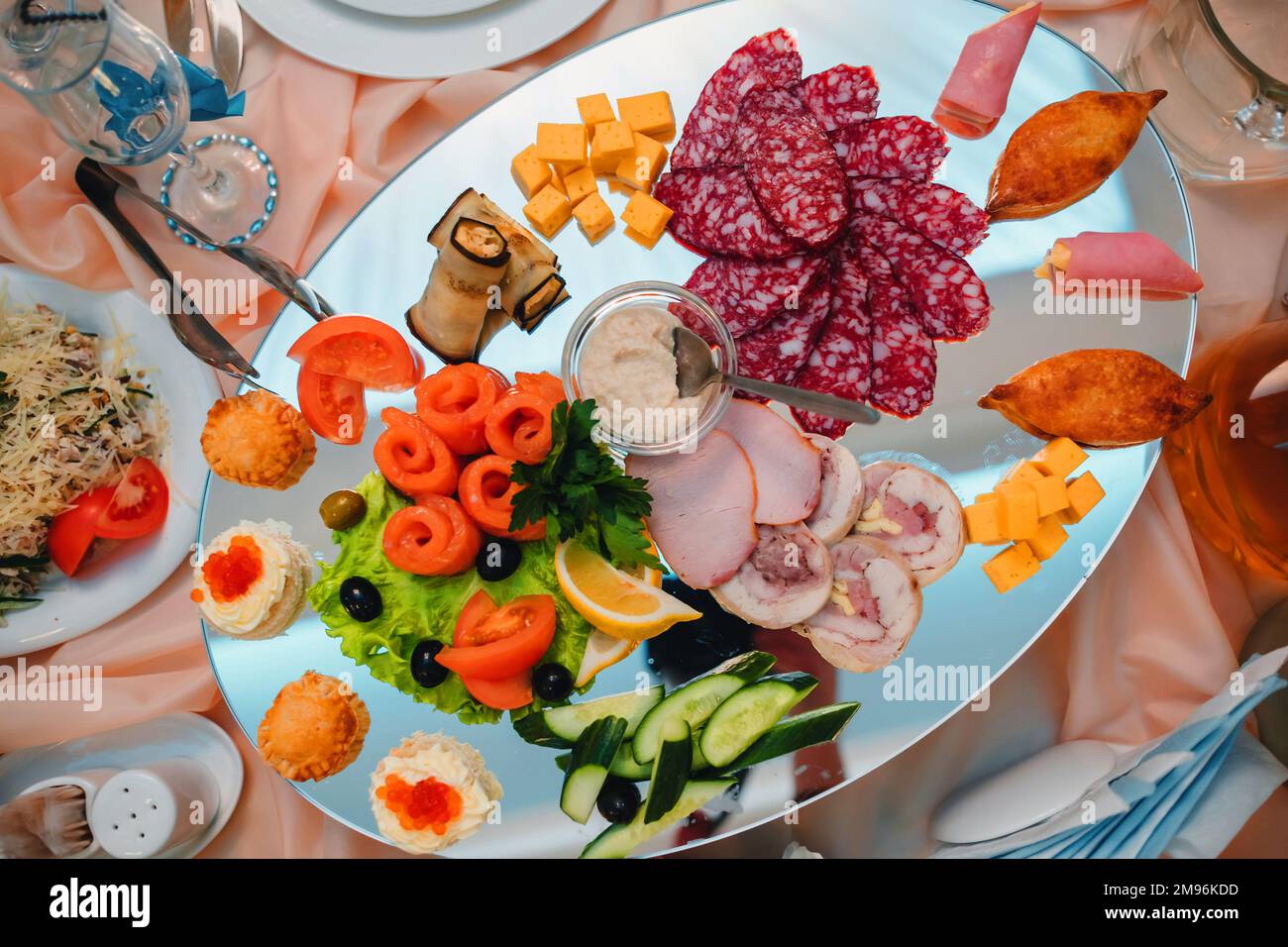 salmon, bacon, sausage, cheese cubes and a variety of snacks on a plate ...