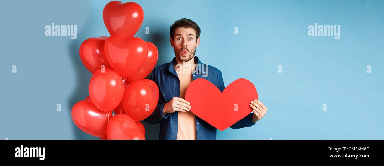 Valentines day concept. Boyfriend in love looking amazed at camera ...