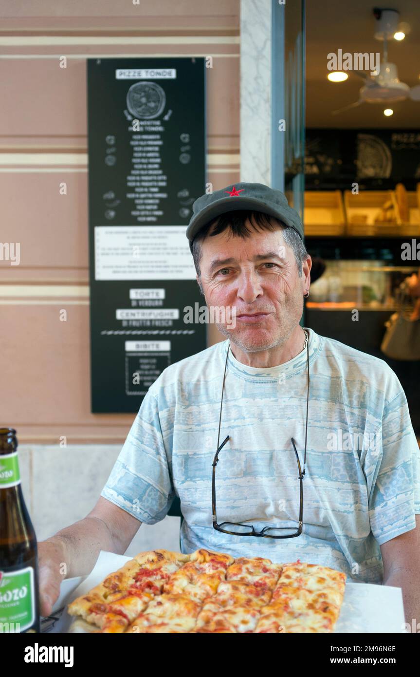 Man eating pizza in restaurant in Levanto, Liguria. Cinque Terre ...