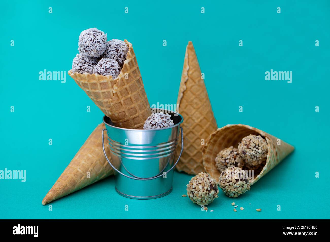 round chocolate candies at ice cream cones. waffle corn on colorful ...