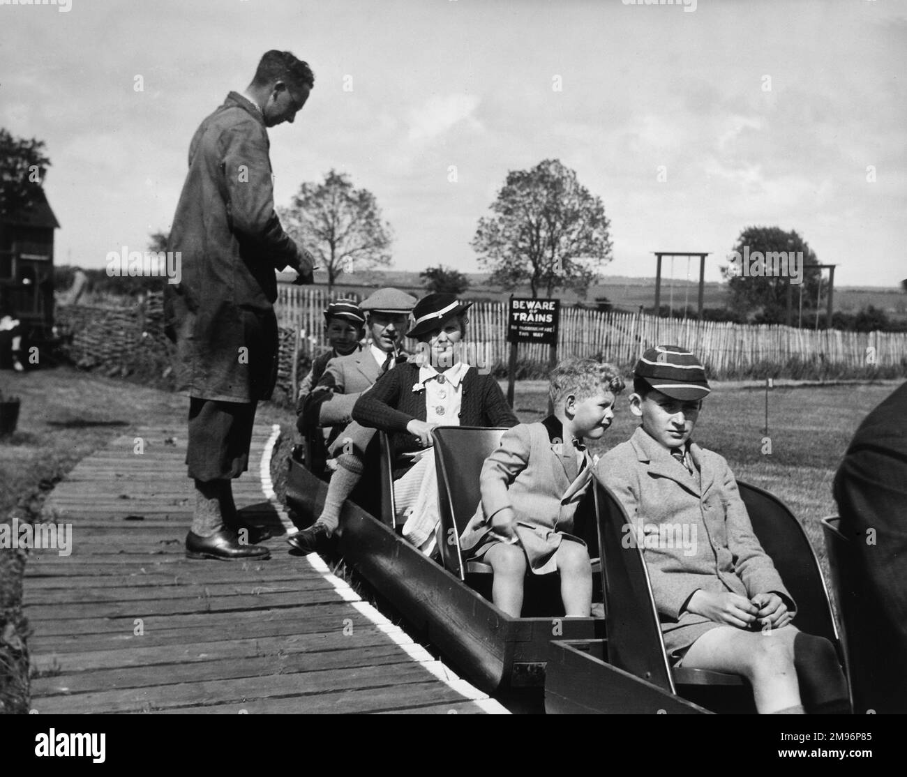 Holidaymakers on a miniature train in Seaford, East Sussex. Two of the ...