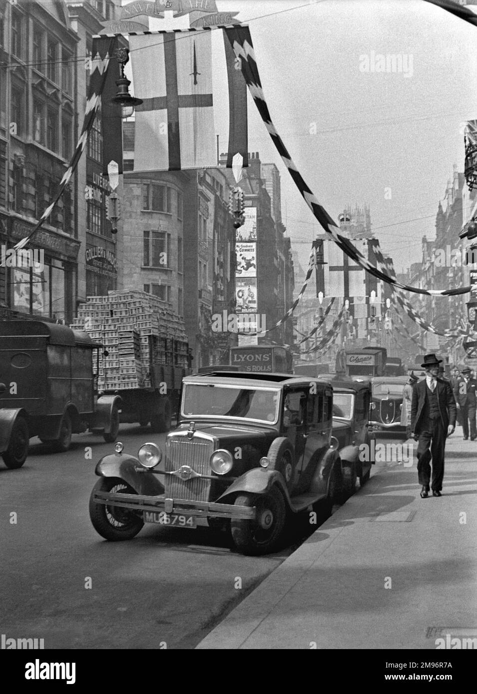 Silver Jubilee street scene in London, with garlands and flags Stock ...