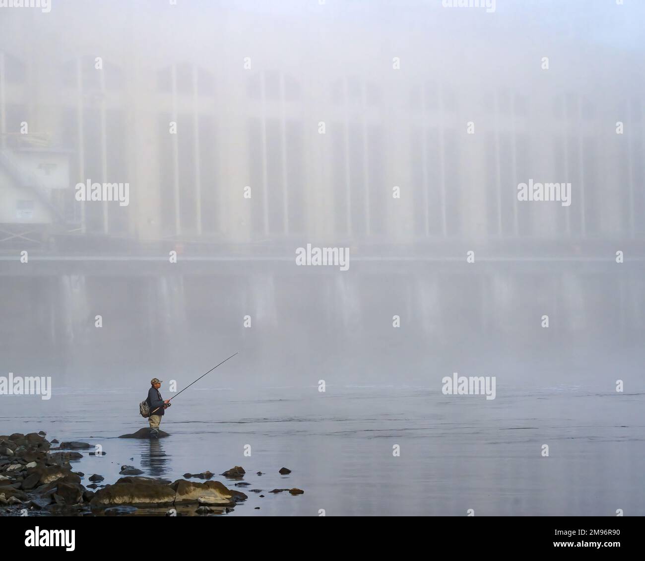 A fisherman fishing in the fog below the Conowingo Dam along the ...