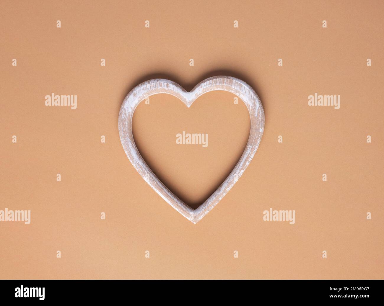 Wooden heart on a beige background. Simple concept for Valentine's day ...