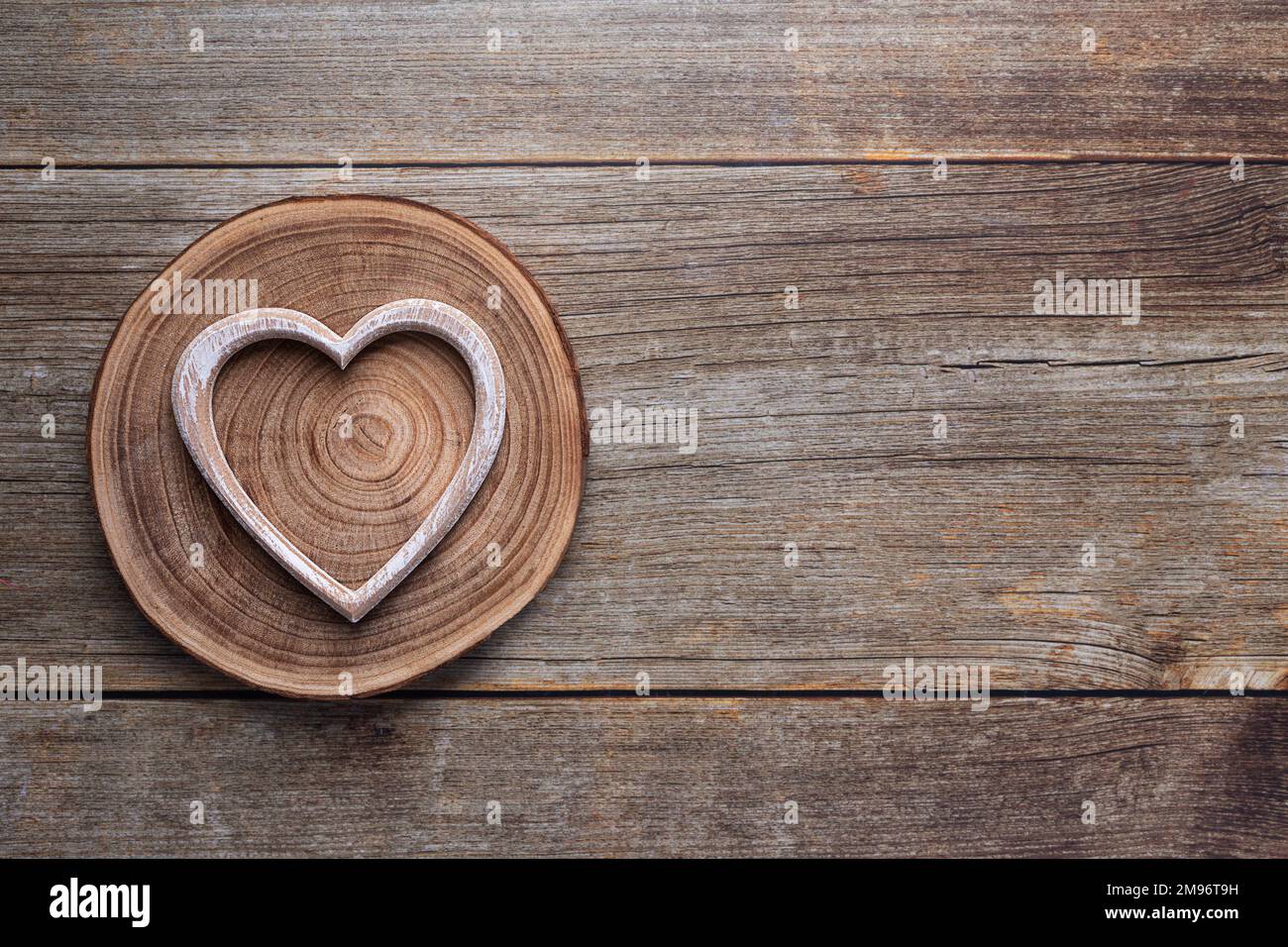 Wooden heart on a brown wooden background. Simple concept for Valentine ...