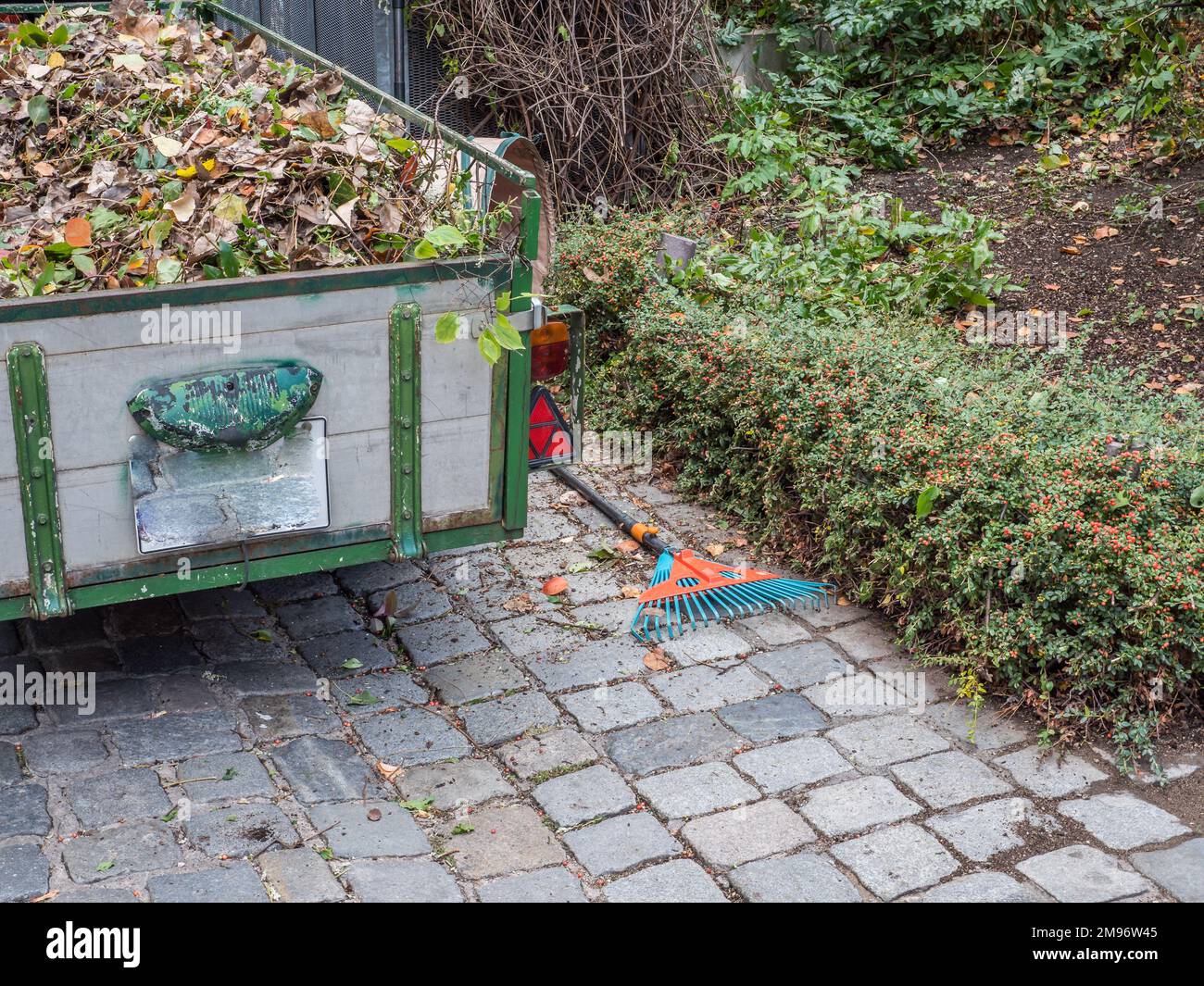 Trailer with garden waste in a park Stock Photo - Alamy