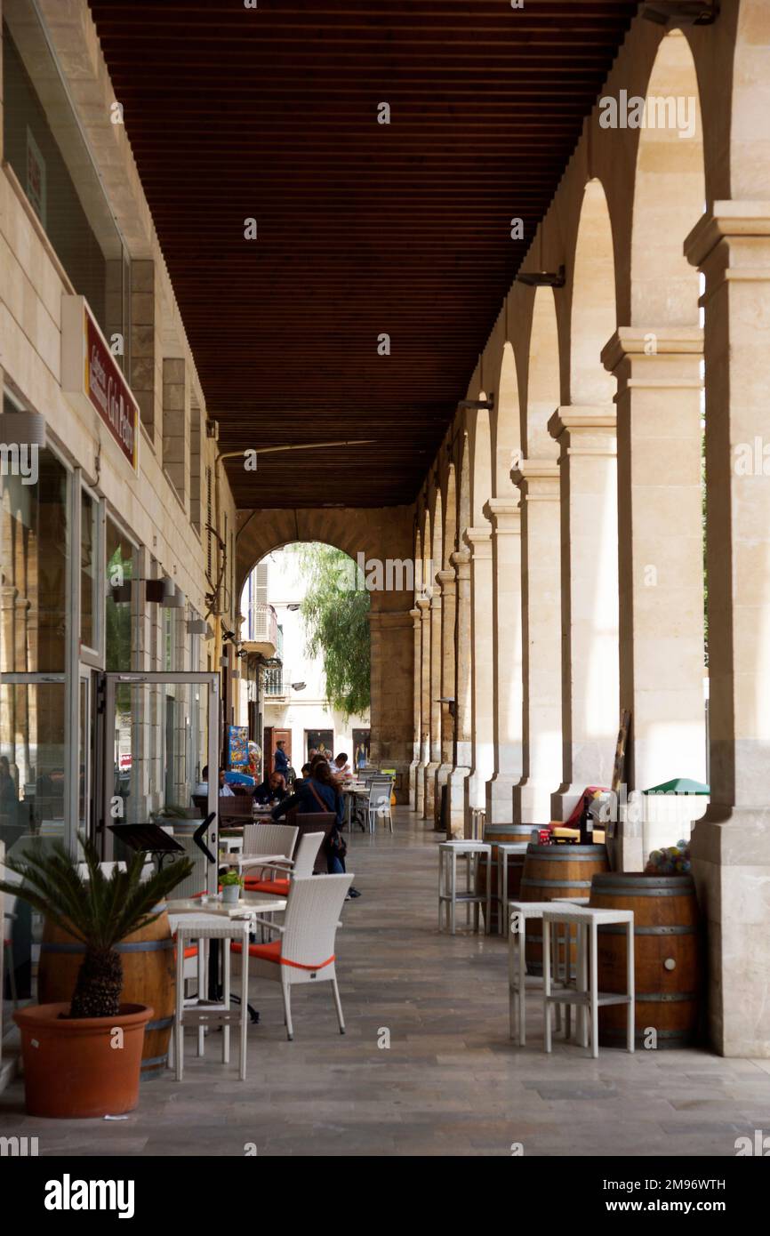 Mallorca, Spain. Arcade at the main square reveals various arches and ...