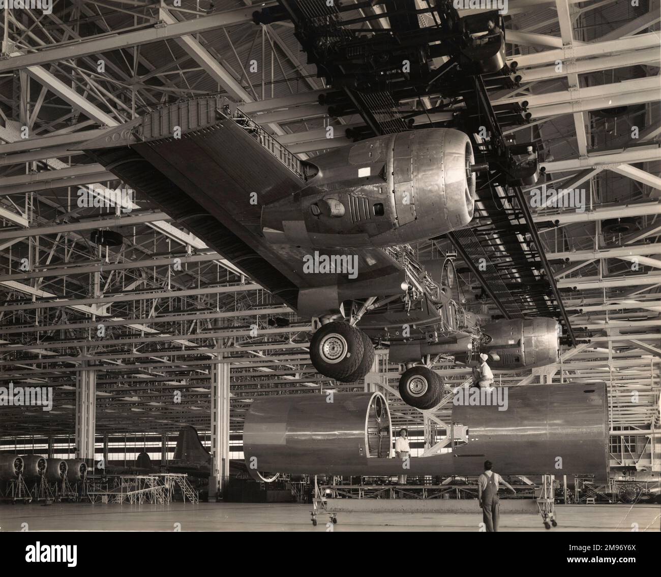 The main centre wing section of a Boeing B-29 Superfortress is lowered ...