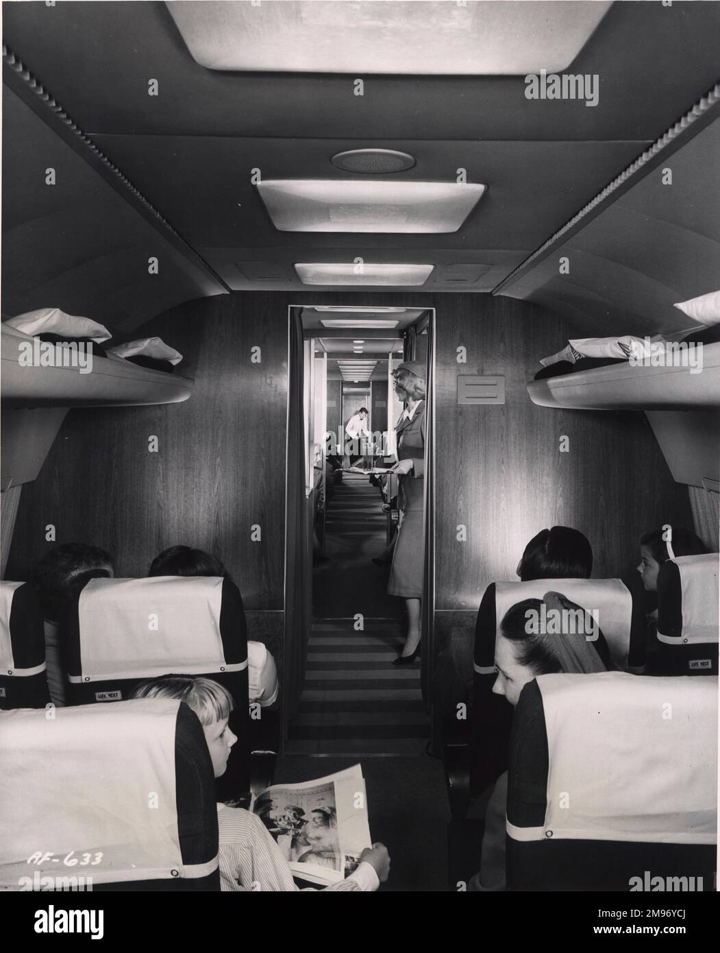 A stewardess serves drinks in a mock-up of aft passenger cabin of a ...