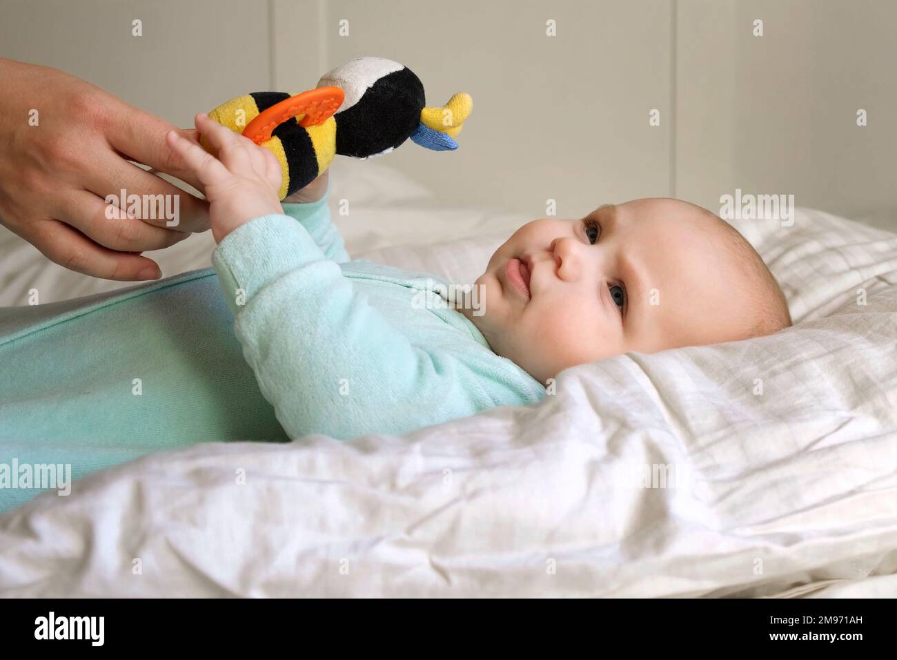 Cute Newborn Baby Lying on the Back and Plays with Colorful Toys ...