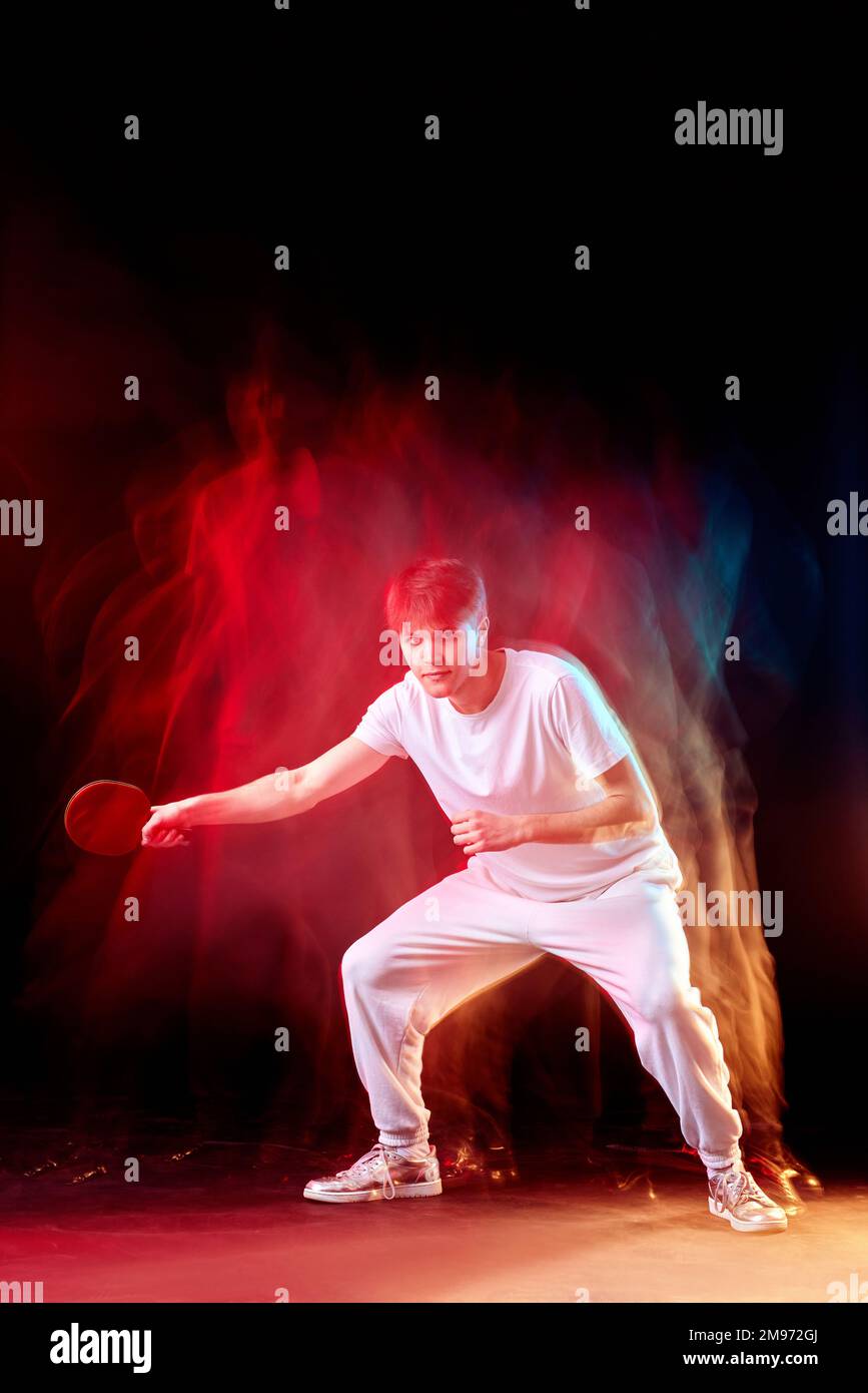 young man playing table tennis in mixed neon light Stock Photo - Alamy