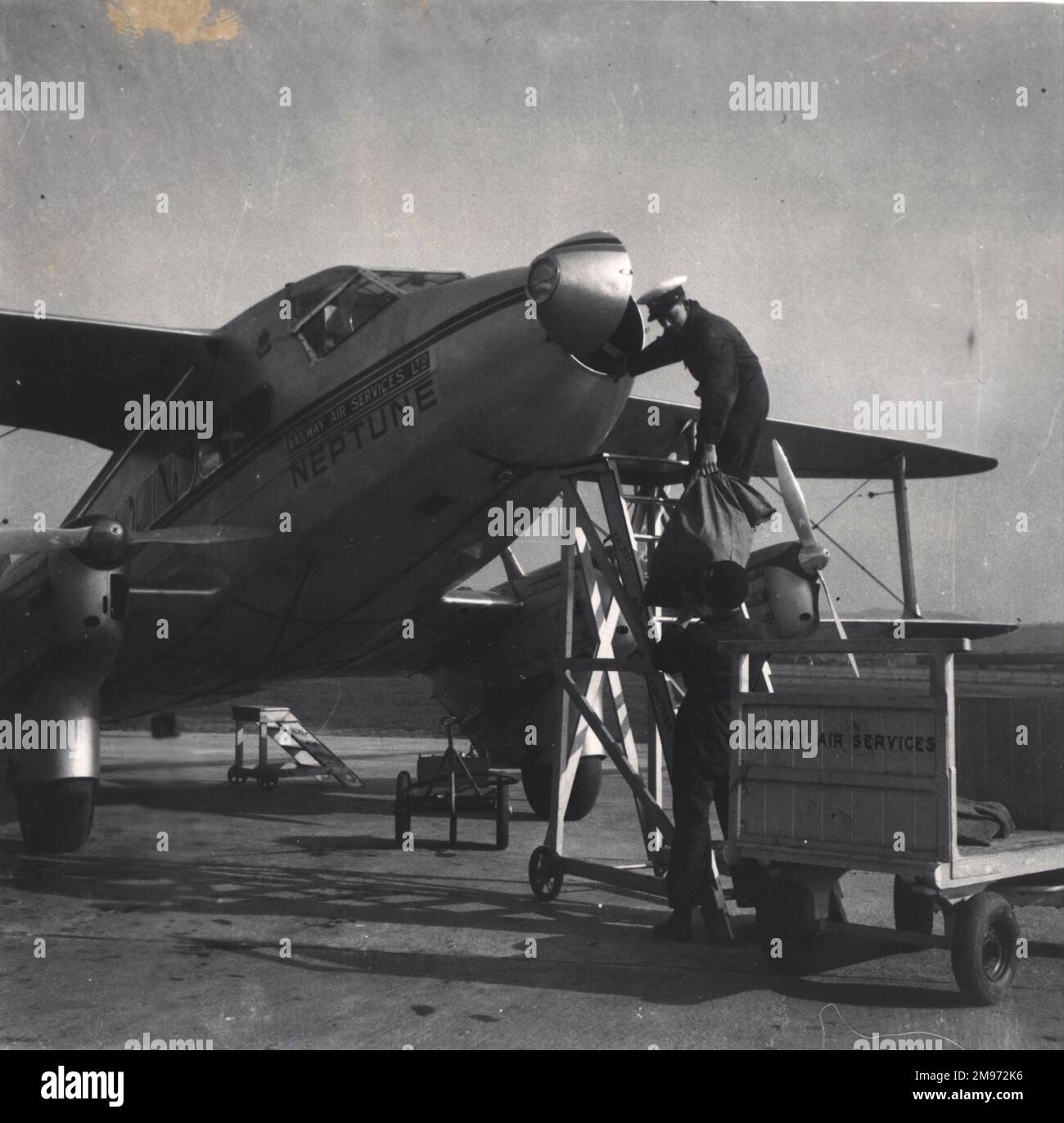Loading mail bags into de Havilland DH86 Express Air Liner, G-AEFH ...