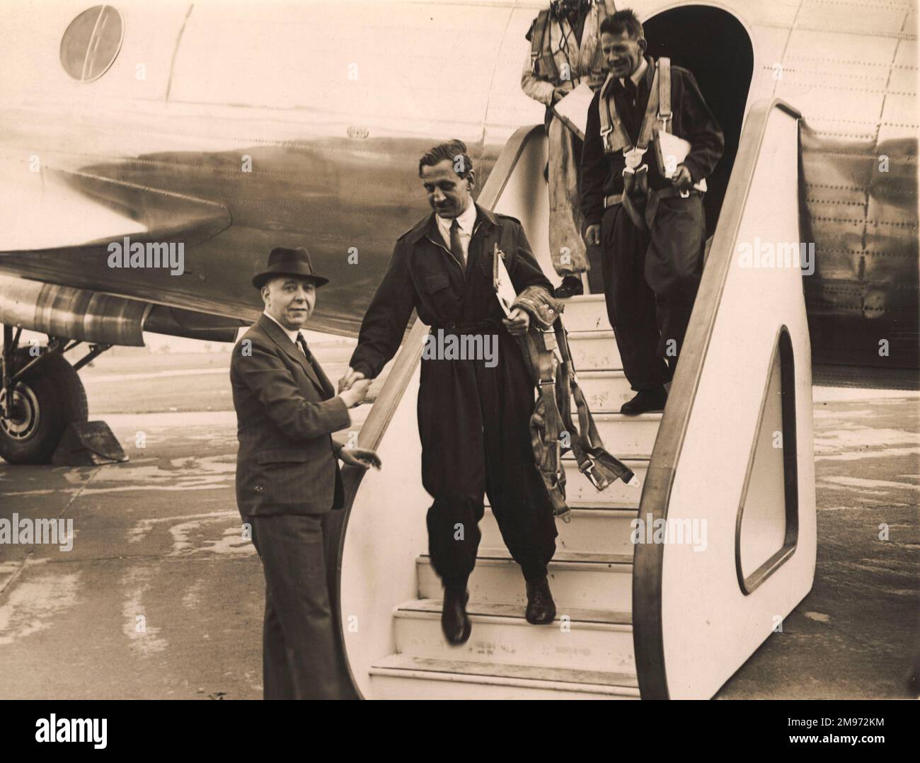 The crew are greeted by Avro’s chief designer, Roy Chadwick, following ...