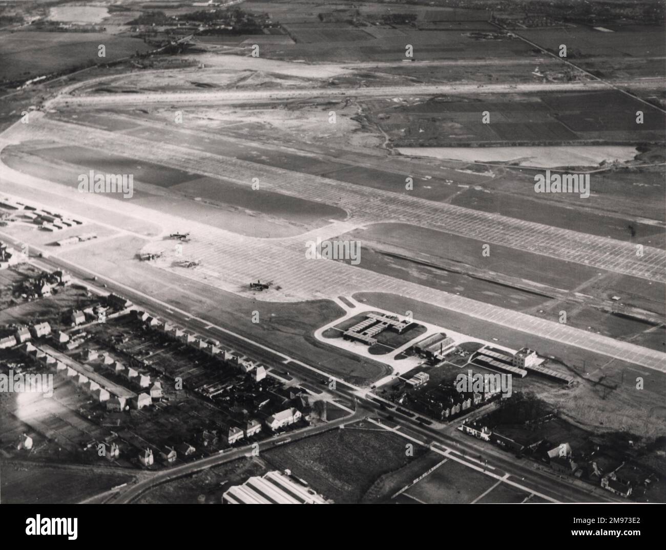 A 1945 aerial view looking south, showing the first runway and terminal ...