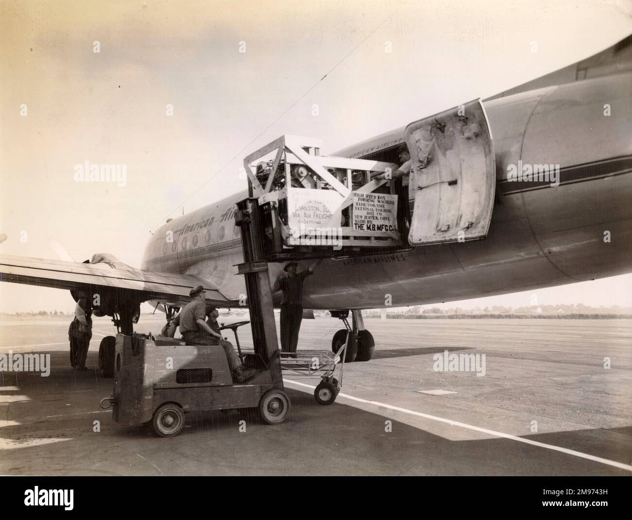 A Douglas DC-4 of American Airlines being loaded with a packaging ...