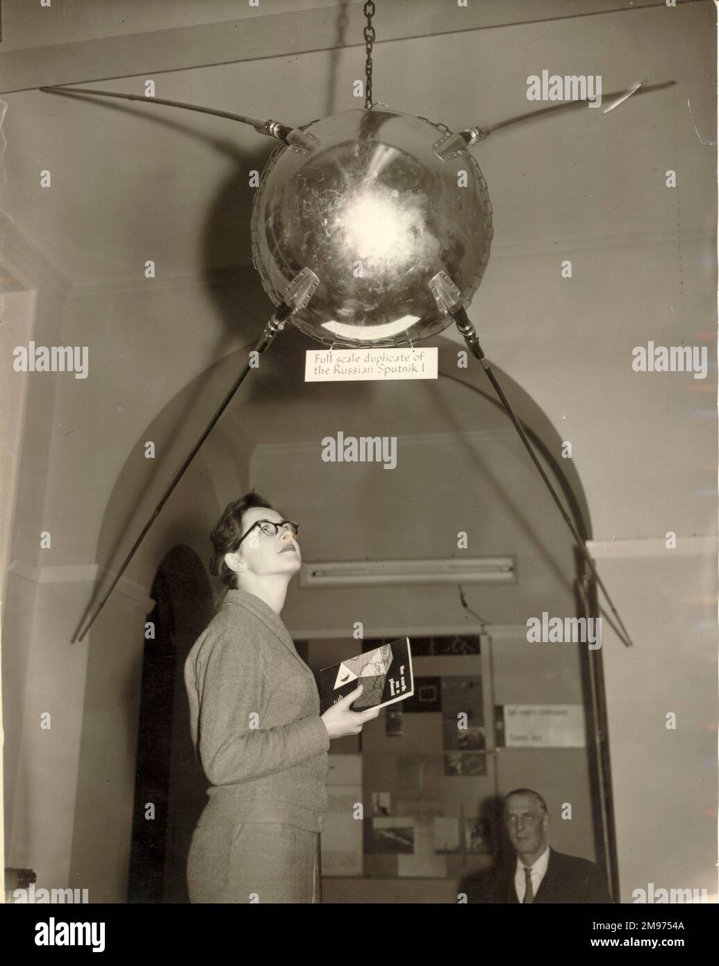 A full-scale replica of Sputnik I is viewed by Isolde Dawe of Acton ...