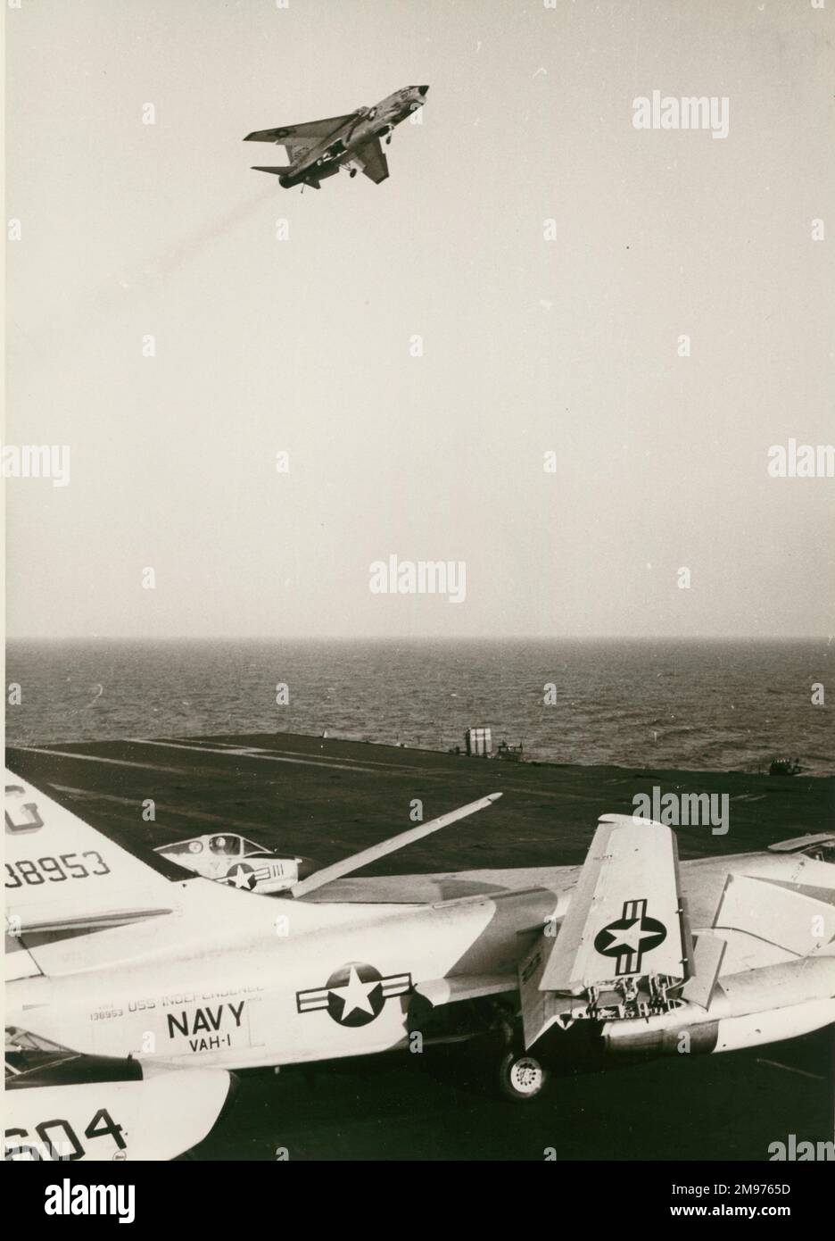 A Vought F-8 Crusader approaches the USS Independence. over Douglas A3D ...