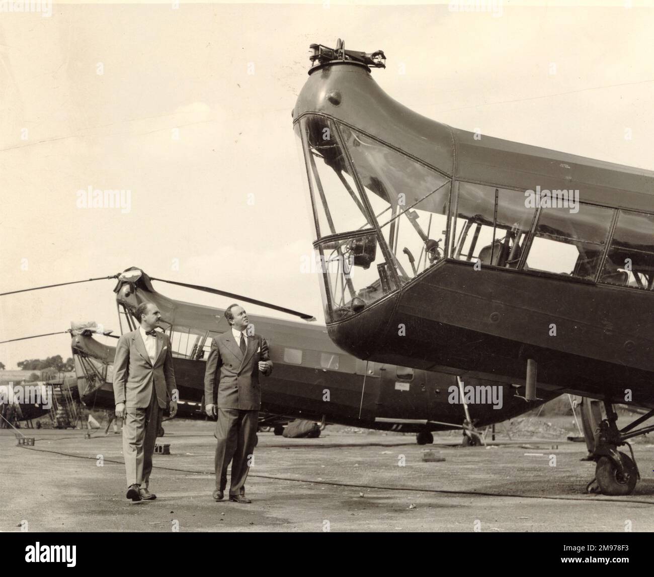 President Frank Piasecki and Vice President Harry Pack walk down a line ...