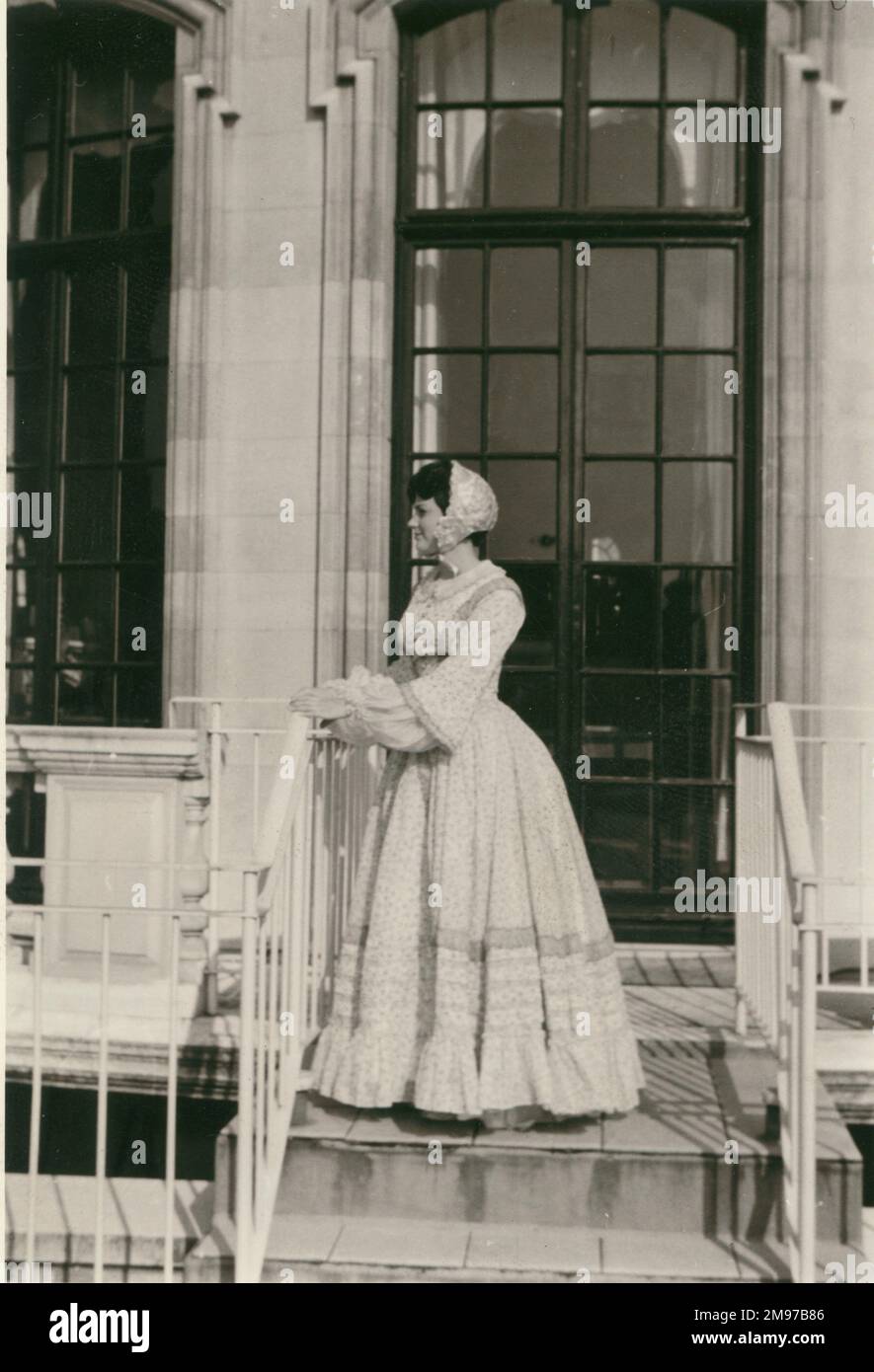 Miss Jenny Thom, RAeS staff member, modelling an 1866 dress in 1966 on ...