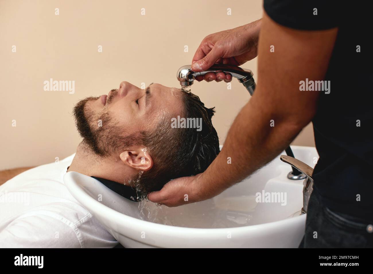 Hands man washing head client hi-res stock photography and images - Alamy
