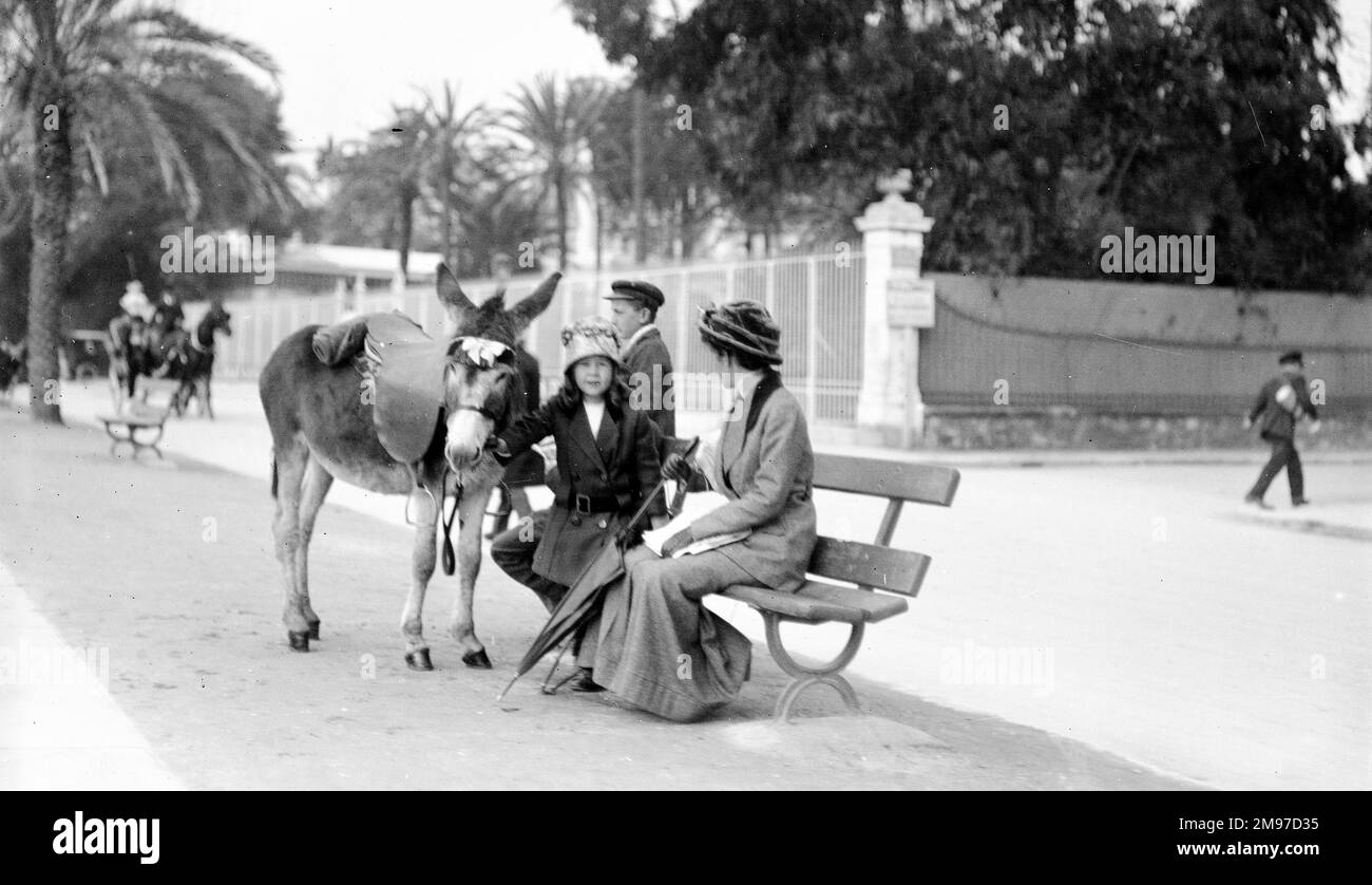 Group with donkey on the promenade at Cannes Stock Photo - Alamy