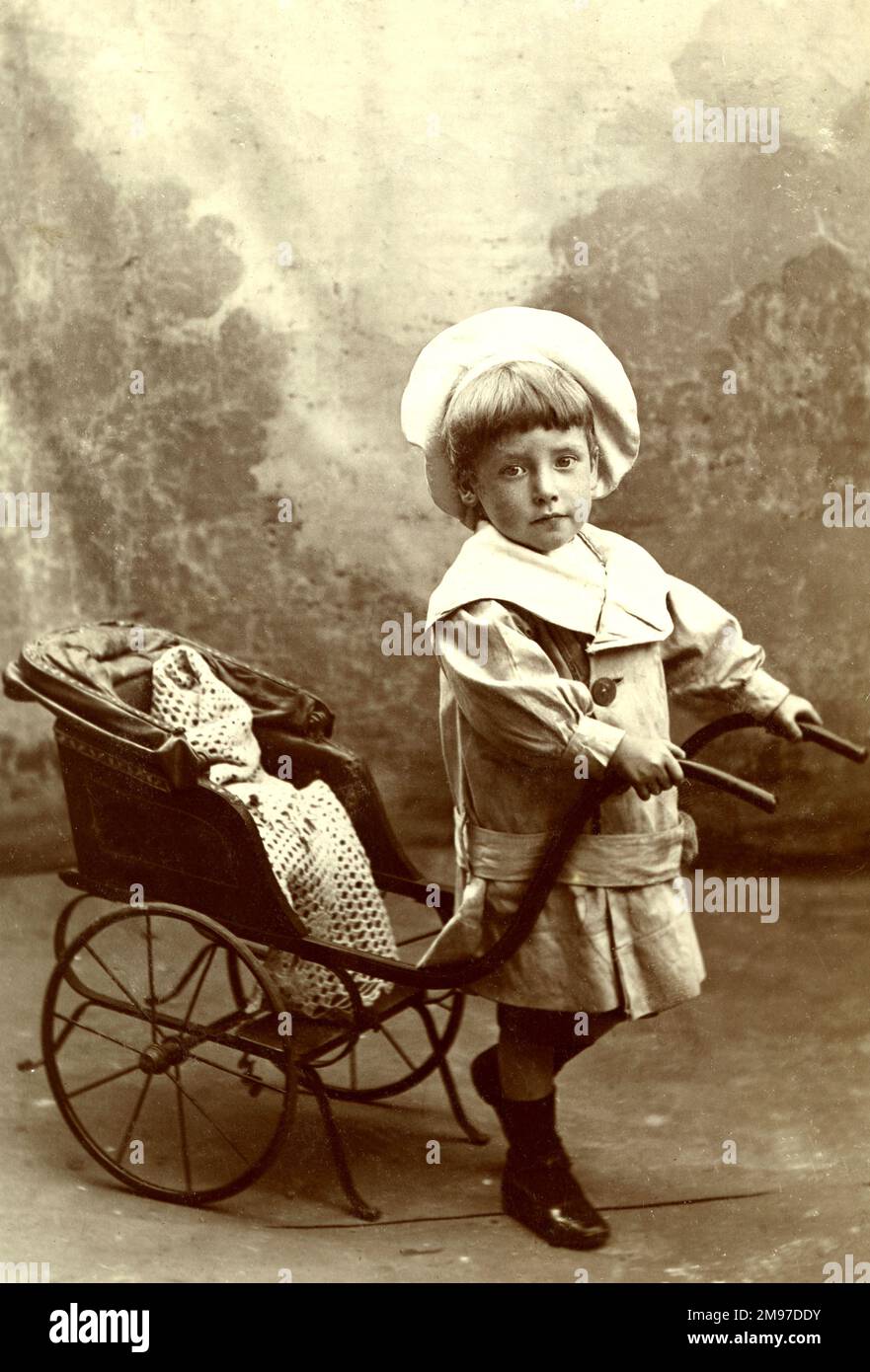 Studio portrait of a young boy with a toy rickshaw Stock Photo - Alamy