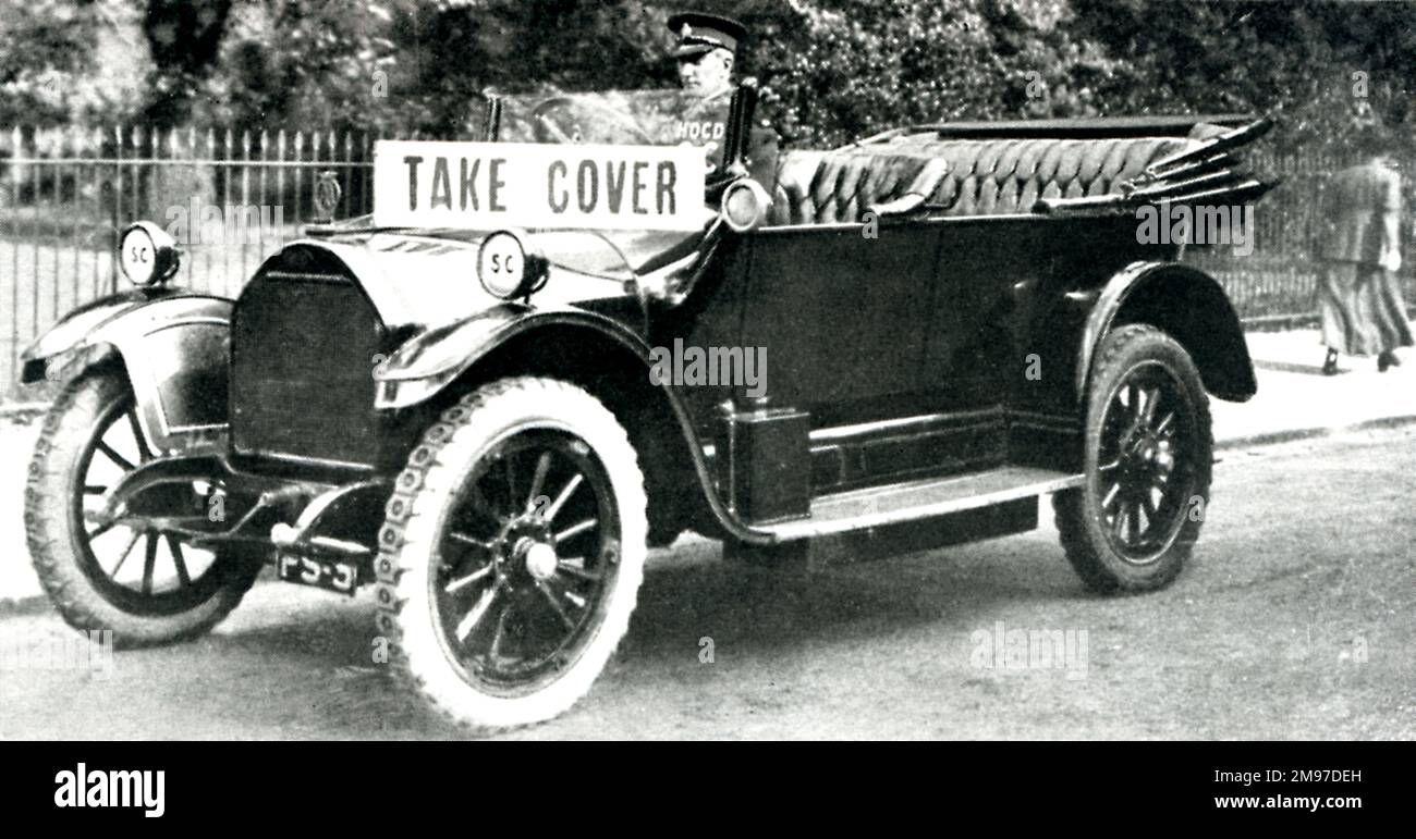 A car with the sign, 'Take Cover' warning the public of an imminent air ...