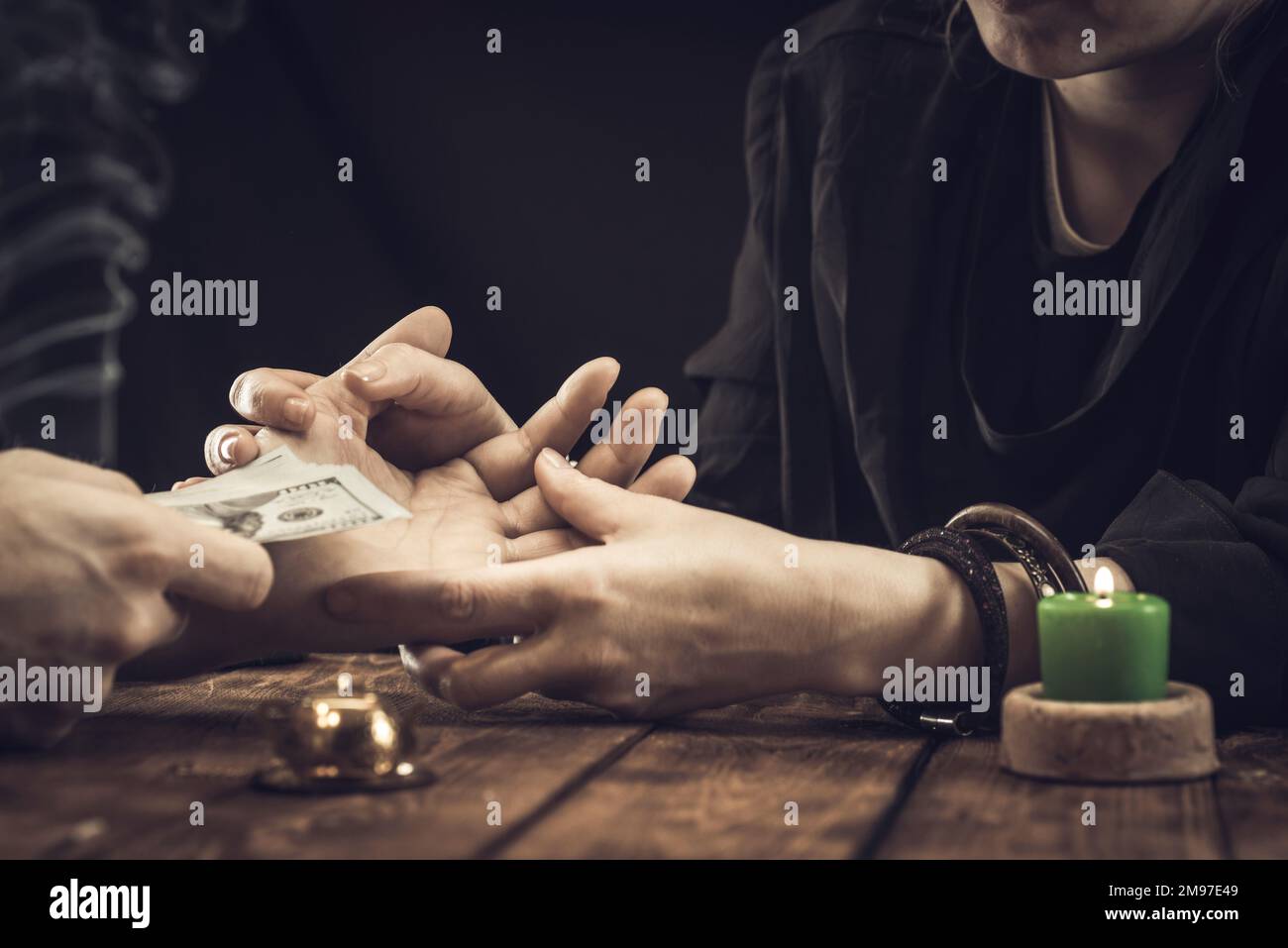 Fortune teller or oracle in search of the lines of fate in the palm of ...